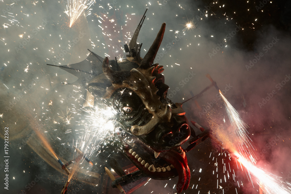 Dragon surrounded by fire in a cultural parade Stock Photo | Adobe Stock