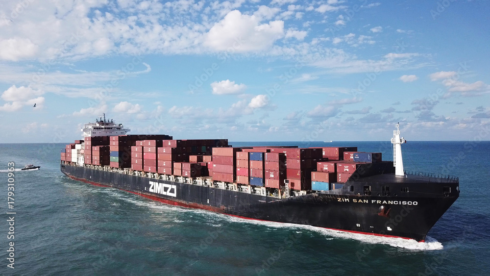 Huge large mega ULCV container ship sails on open water fully loaded ...