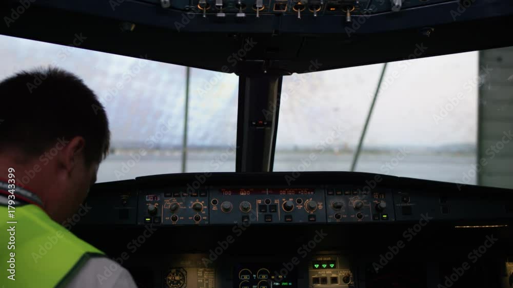 Pilot in cockpit flying. The interior of the aircraft cabin with the ...