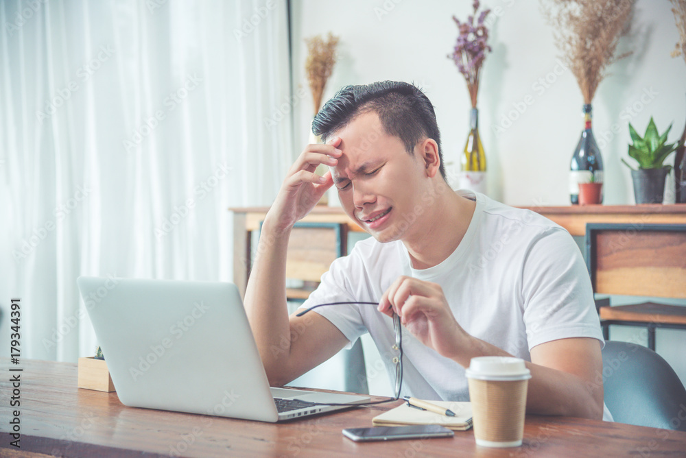 Young asian man sitting on chair and crying because his work is not ...