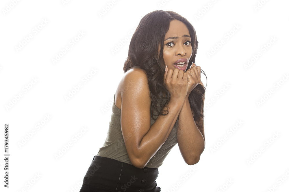 Frightened Black female isolated on a white background displaying facial expressions. She is ...