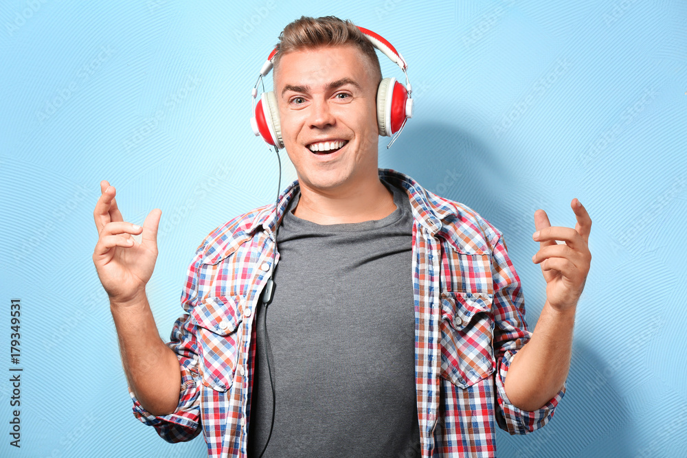 Handsome man listening to music on color background Stock Photo | Adobe ...