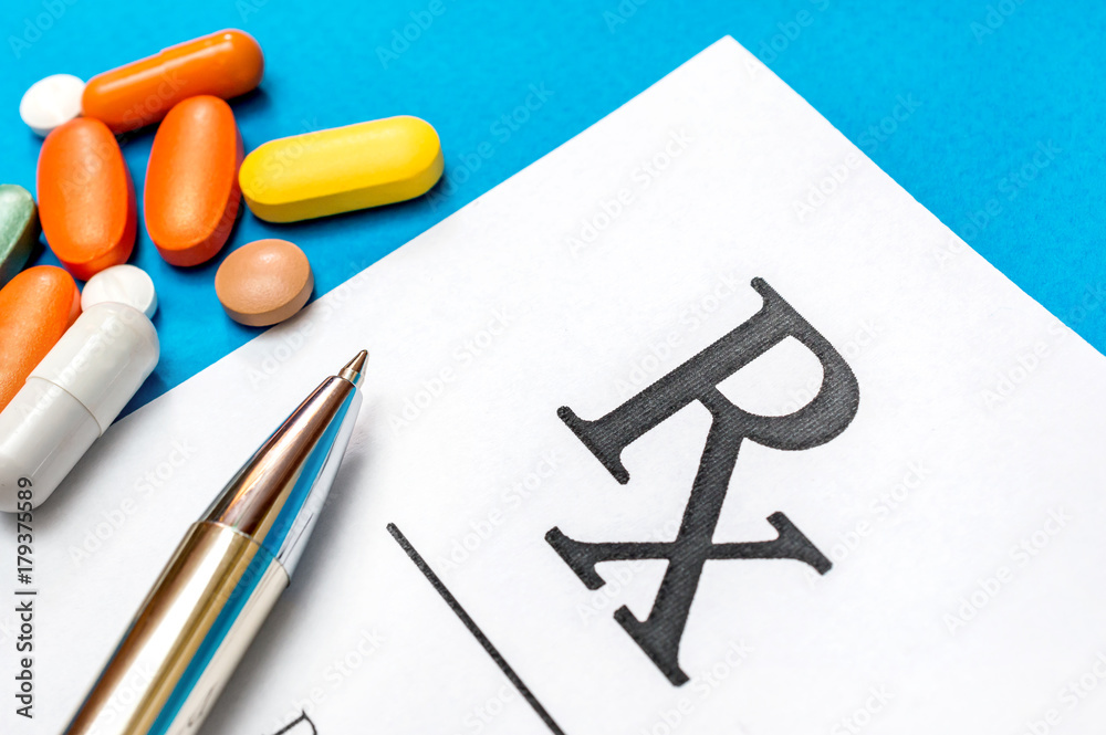 Prescription form with pen and pills on a blue background. Medical ...