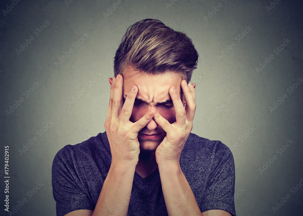 Sad young man looking down. Depression and anxiety disorder concept ...