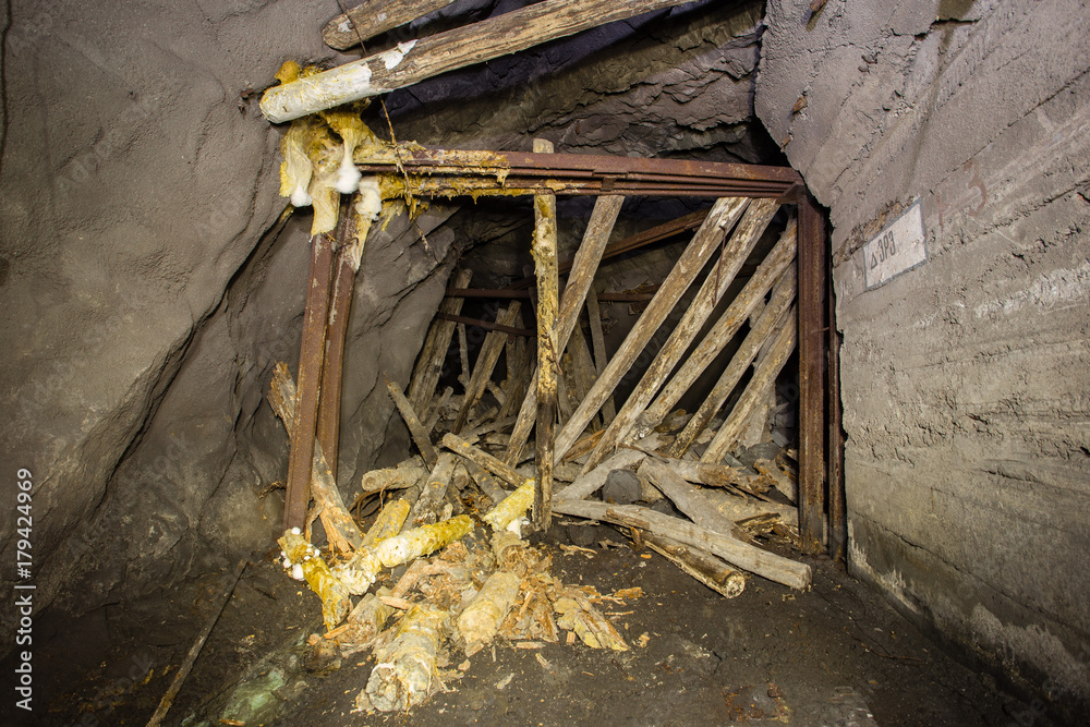 Underground mine shaft iron ore tunnel gallery with collapsed timbering ...
