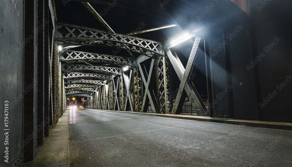 Asphalt road under the steel construction of a bridge in the city ...