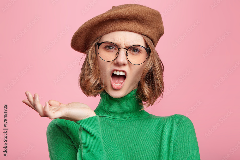 Angry indignant pretty female frowns face in dissatisfaction being ...