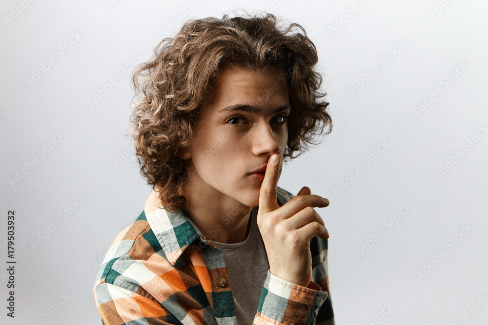 Picture of attractive young man in trendy clothes posing in studio with ...