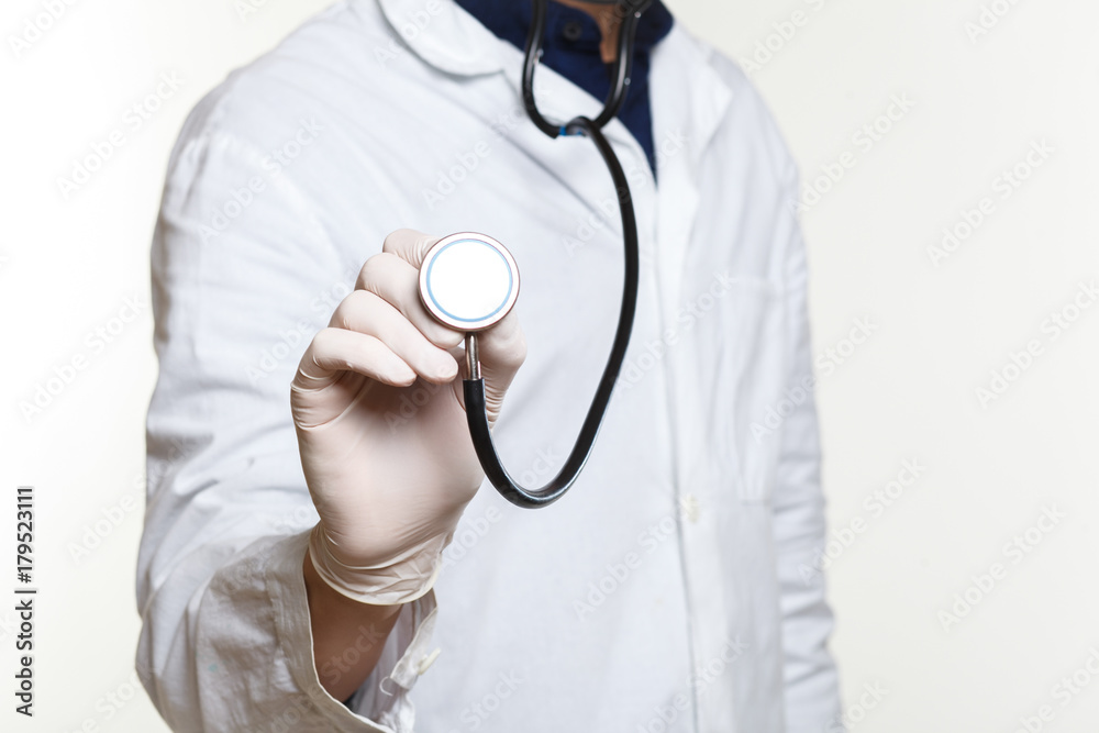 beautiful young doctor in a dressing gown with a stethoscope on a white ...