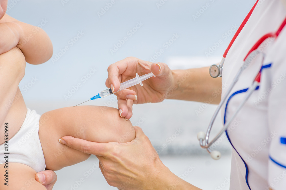 doctor makes a baby an injection in the leg Stock Photo | Adobe Stock