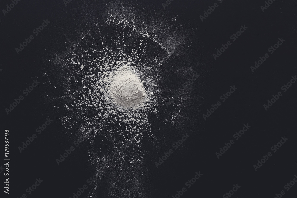 Sprinkled wheat flour splash spots on black background Stock Photo ...
