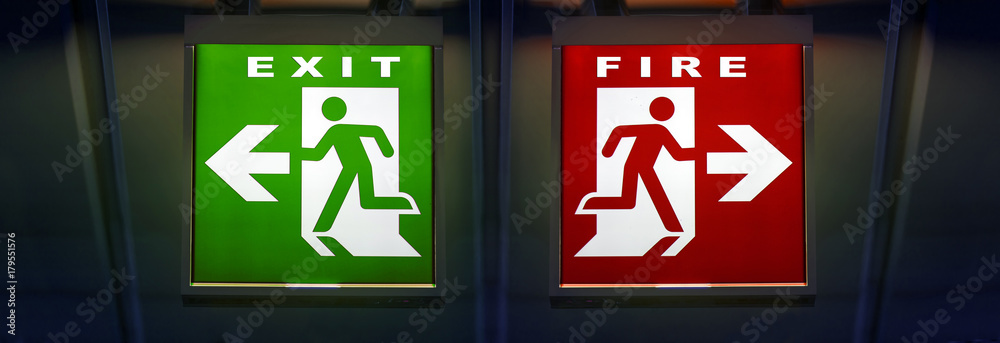 The signpost shows two path directions. Choice of way, Exit and Fire ...