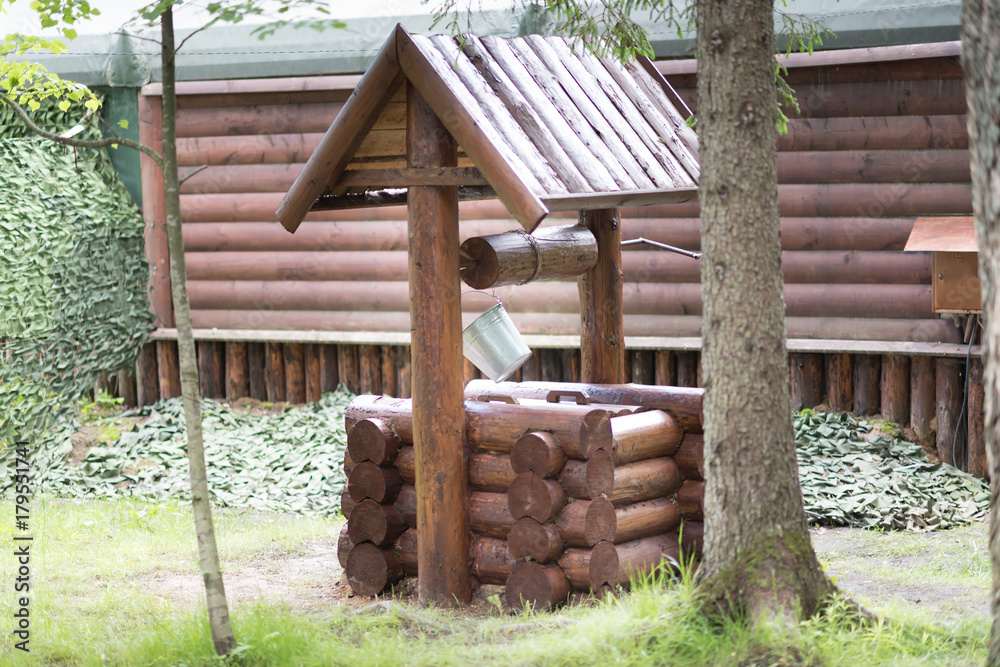 Water well with bucket Stock Photo | Adobe Stock