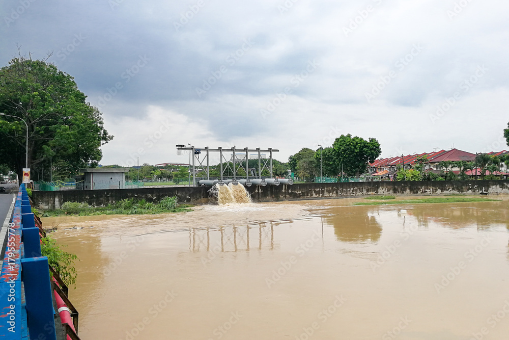 Rain water pumped into river from flood storm retention pond Stock ...