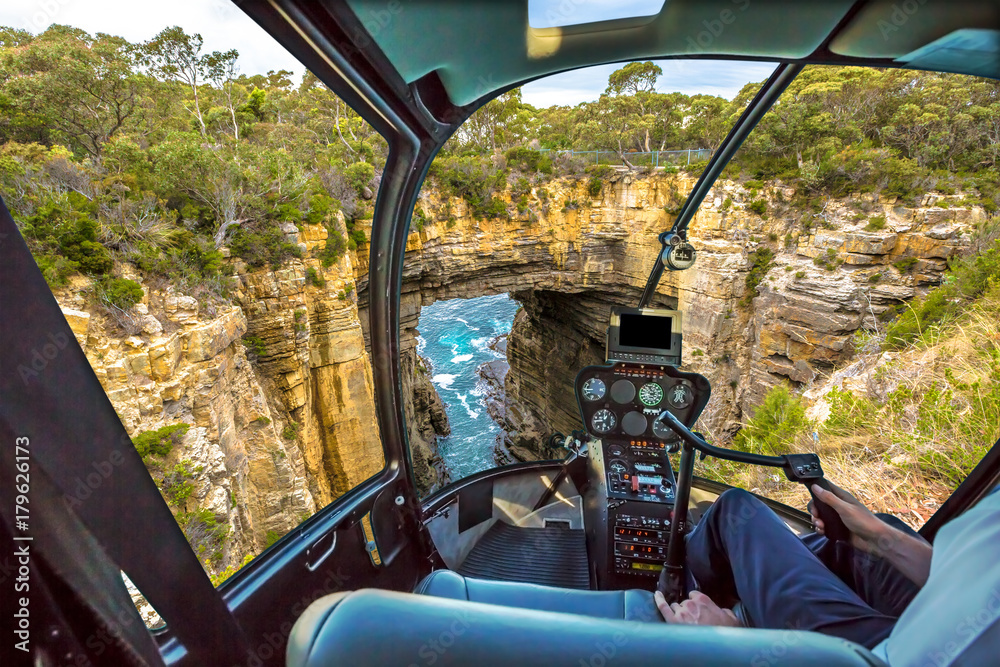 Helicopter cockpit with pilot arm and control console inside the cabin ...