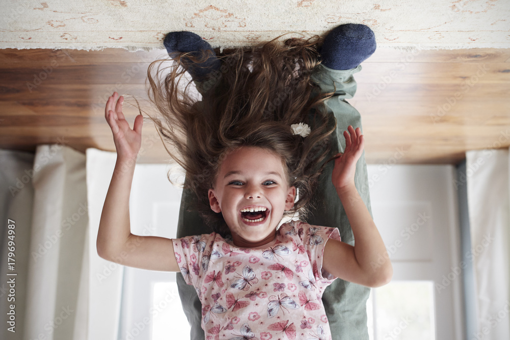 Girl Being Held Upside Down By Her Dad At Home Low Section Stock Photo