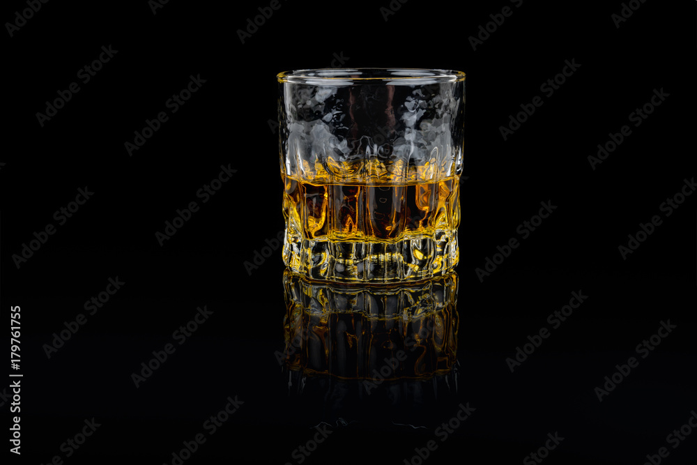 Beautiful golden tasty whiskey in a classic whiskey glass. Isolated ...