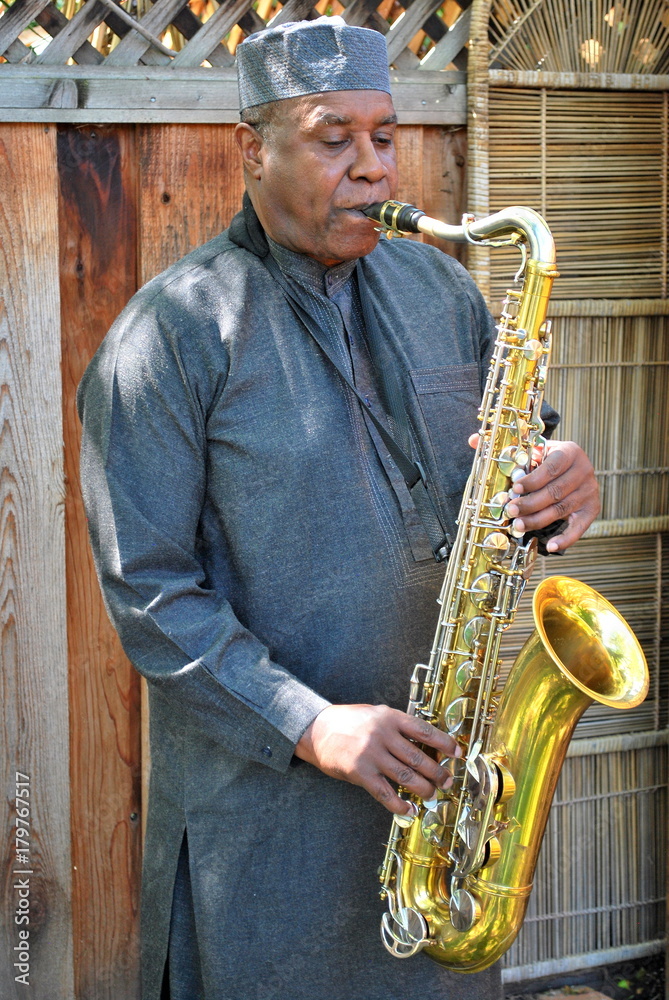 Muslim male jazz musician with his tenor saxophone outdoors. Stock ...