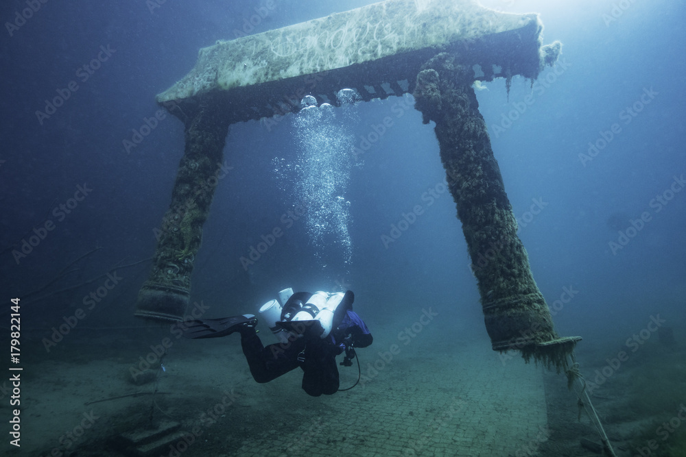Scuba diver in german lake diving through asian gate Stock Photo ...