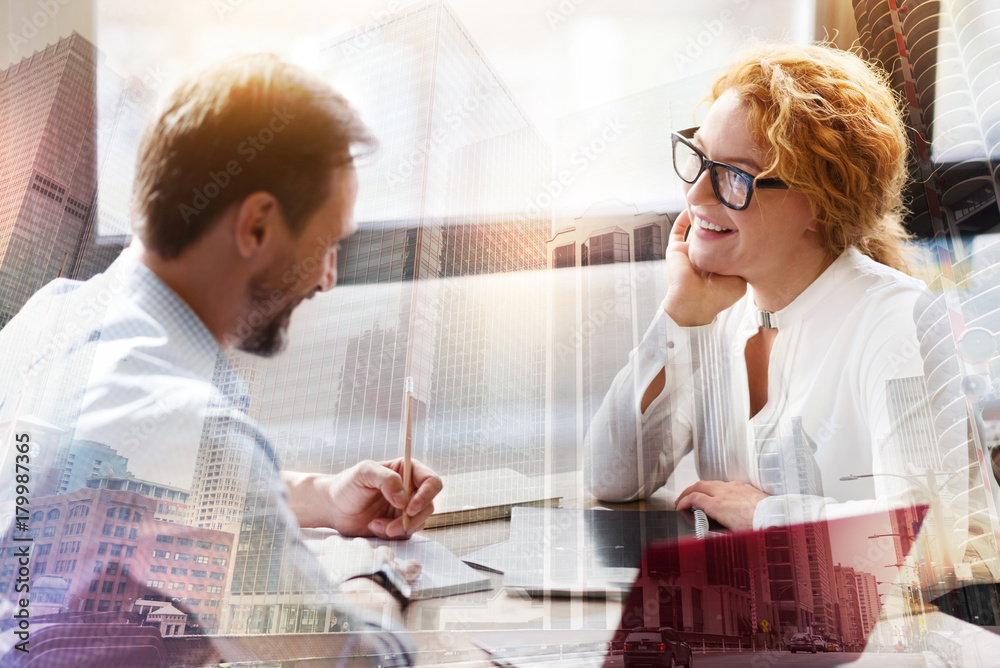 Delightful conversation. Two cheerful office workers sitting the table ...