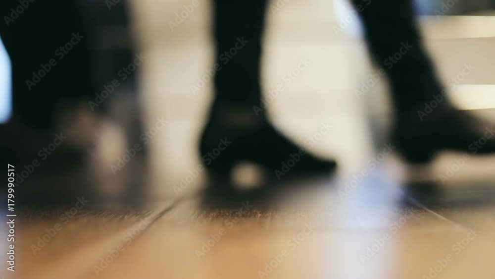 close-up walking shoes crowd people public space moving slow motion ...