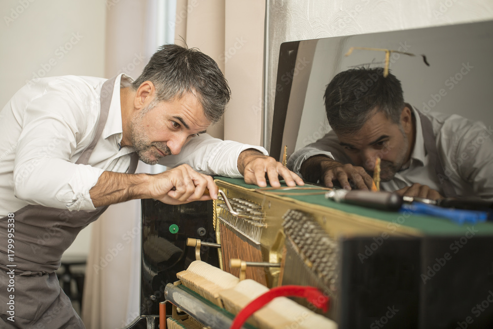 Technician tuning a upright piano using lever and tools Stock Photo ...
