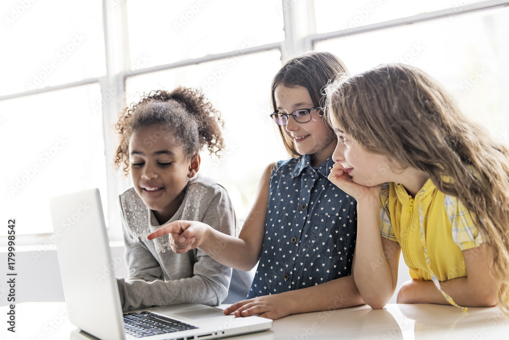 Group of curious children watching stuff on the laptop screen Stock ...