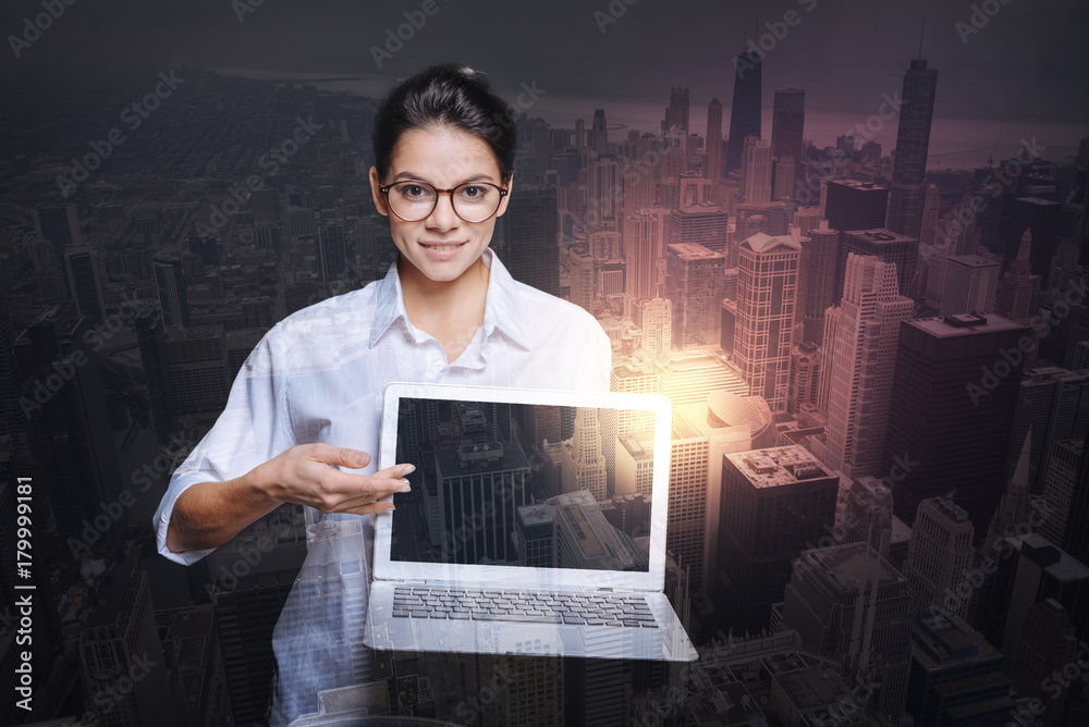 Look here. Calm cheerful clever worker showing a presentation while ...