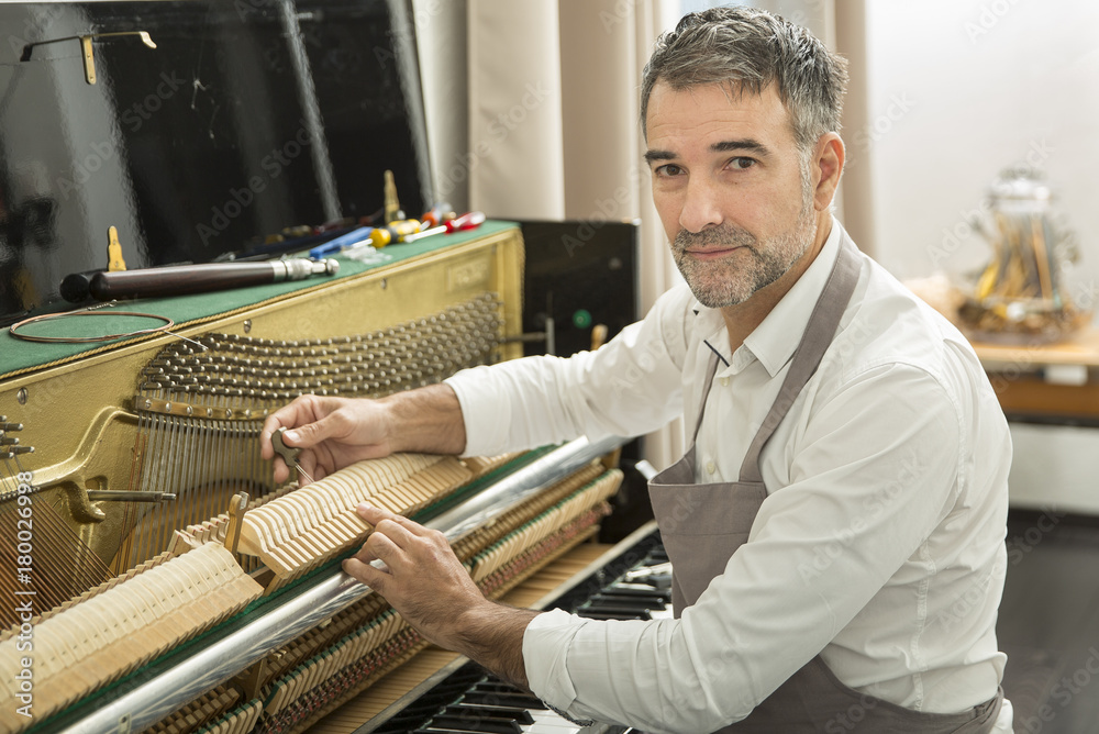 Technician tuning a upright piano using lever and tools Stock Photo ...