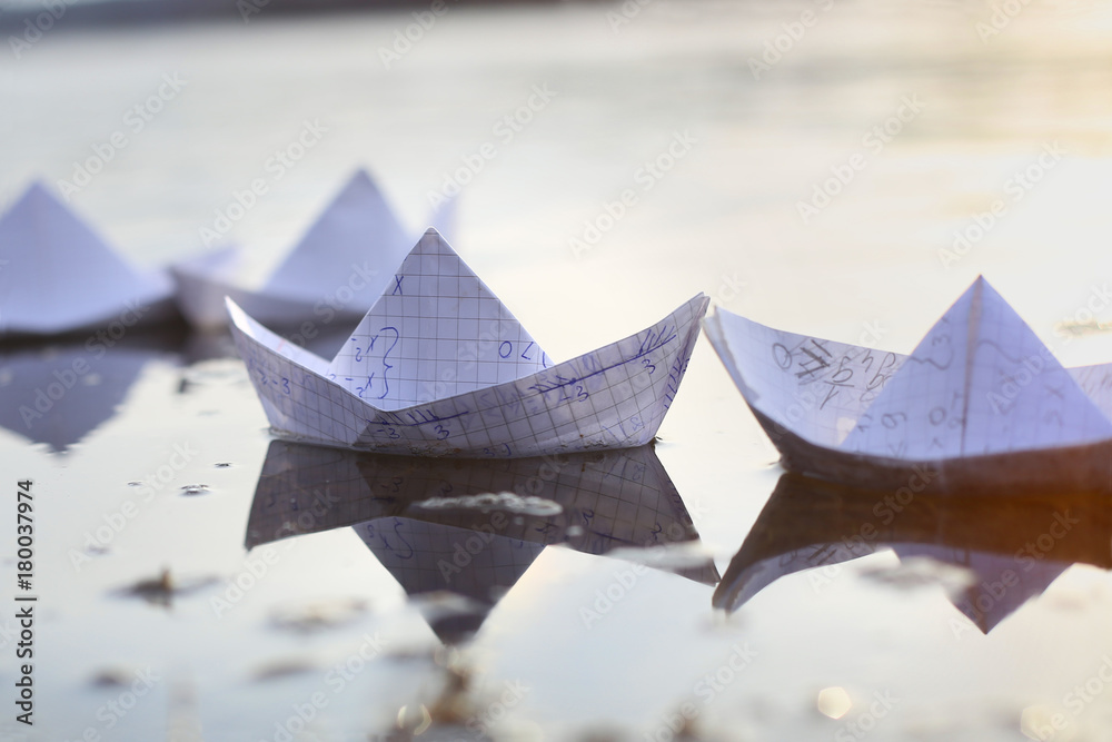 Origami paper ships sailing in river. Paper boats made from mathematics ...