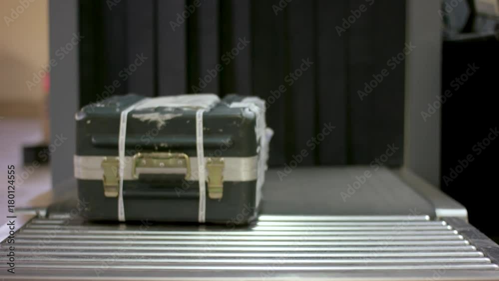 Check baggage at the airport x-ray scanner. Man traveler selective ...