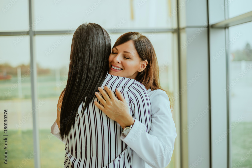 Caring young medical doctor hugging patient. Stock Photo | Adobe Stock