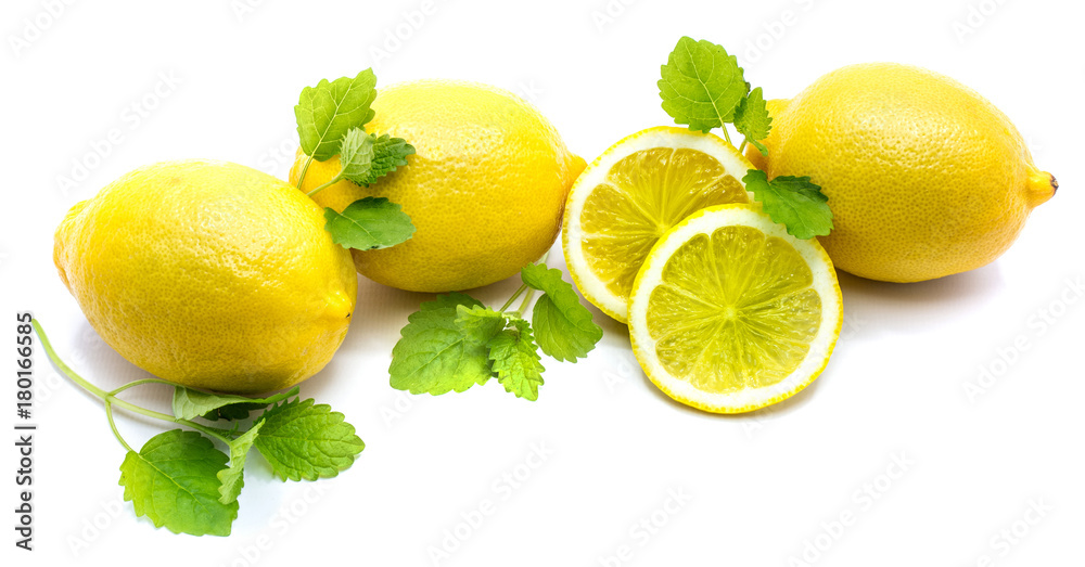 Composition of three whole lemons and two slices on fresh green lemon ...