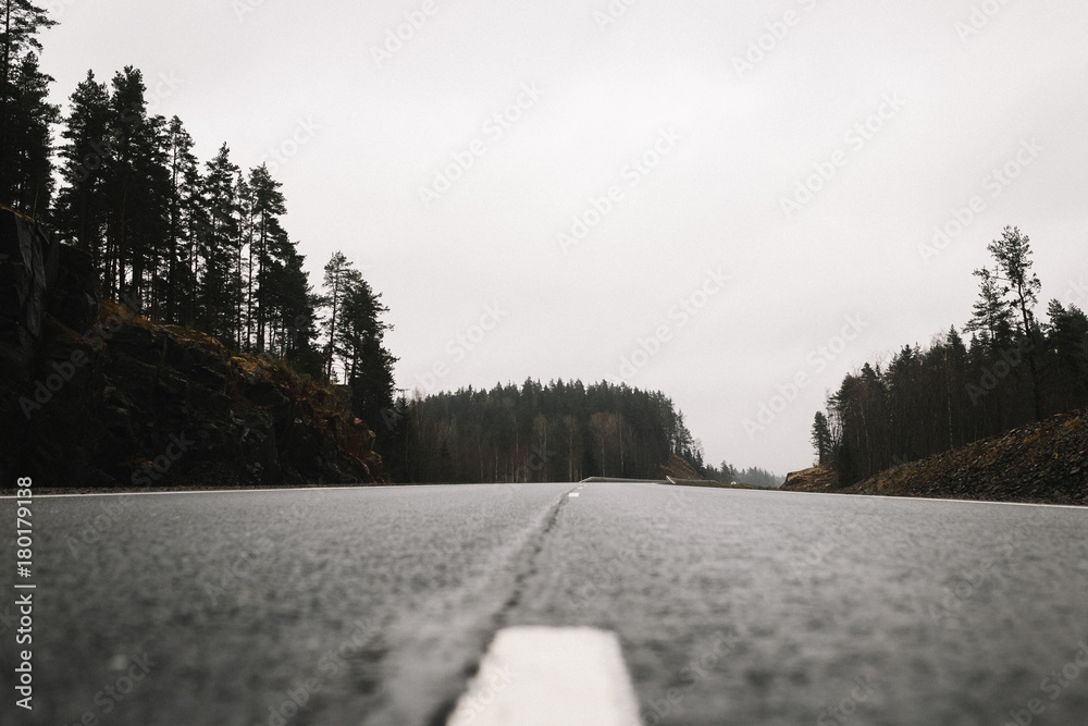 Asphalt road in the middle with a light fog in the rainy weather low ...
