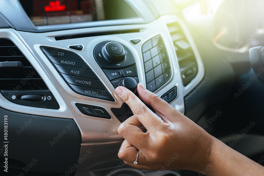 Hand turning on car radio system,Button on dashboard in car panel Stock ...