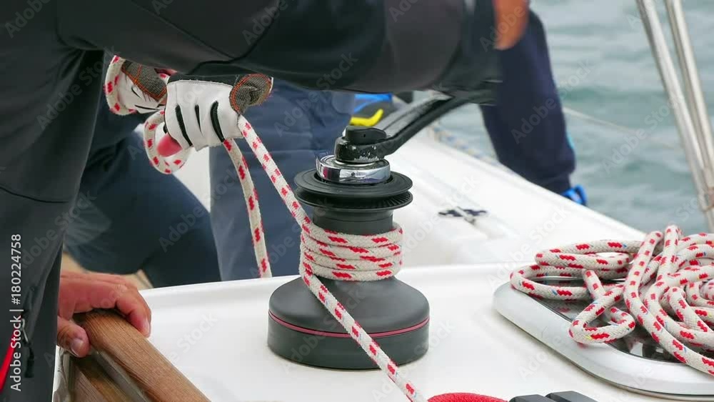 Vídeo do Stock: Sailing crew pulling out main sail with winding rope on ...