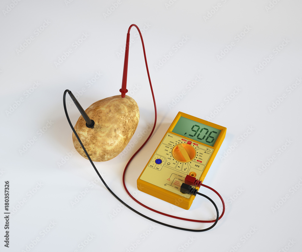 Potato battery on white background. Multimeter with positive and ...