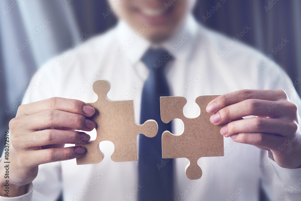 Happy Man is trying to connect couple puzzle piece. Symbol of ...