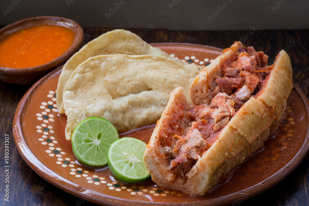 Authentic Mexican torta ahogada pork meat sandwich soaked in hot tomato ...