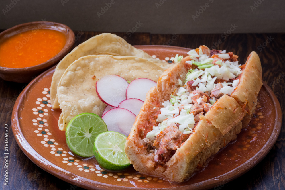 Authentic Mexican torta ahogada pork meat sandwich soaked in hot tomato ...