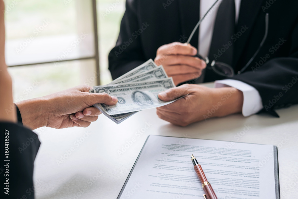 Bribery and corruption concept, bribe in the form of dollar bills ...