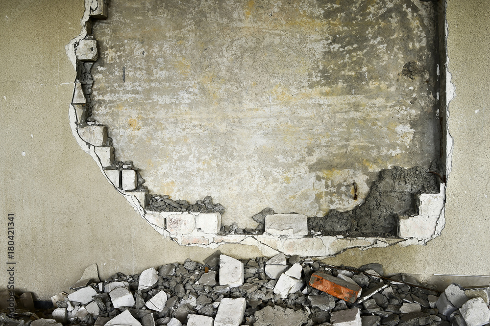 Foto de Partially destroyed wall inside an industrial building under ...