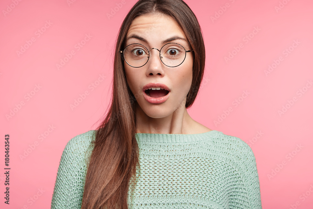 Isolated shot of scared Asian female in glasses afraid of something ...