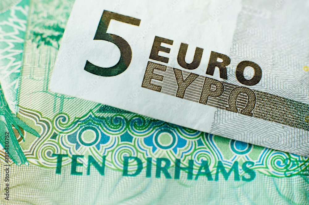 5 Euro Note On Top Of A United Arab Emirates 10 Dirhams Banknote 5-euro-note-on-top-of-a-united-arab-emirates-10-dirhams-banknote
