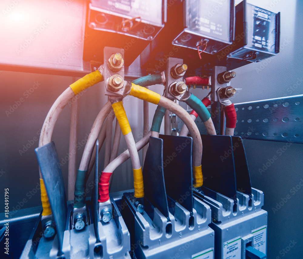 Wires and switches in electric box. Electrical panel with fuses and ...