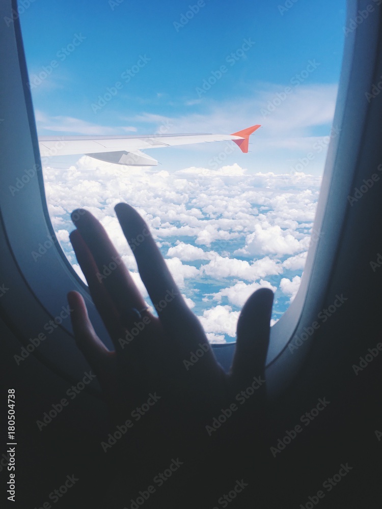 View from airplane window to sky and air plane wing, white clouds ...