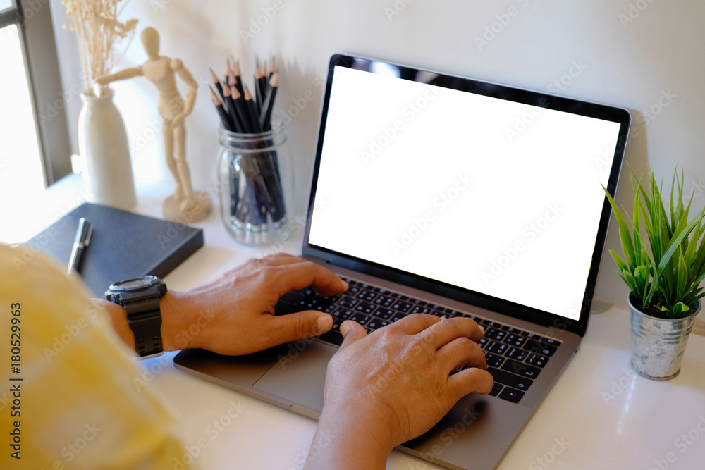 Mockup image of male hands using laptop with blank white screen in ...