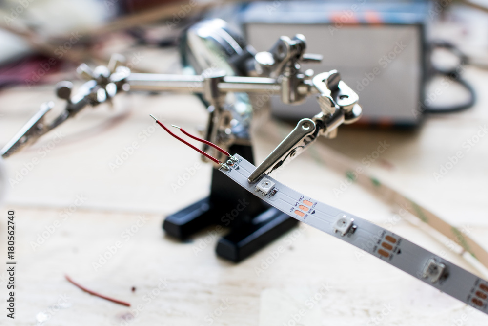 welding for LED strips on third hand for electronics jobs. making ...
