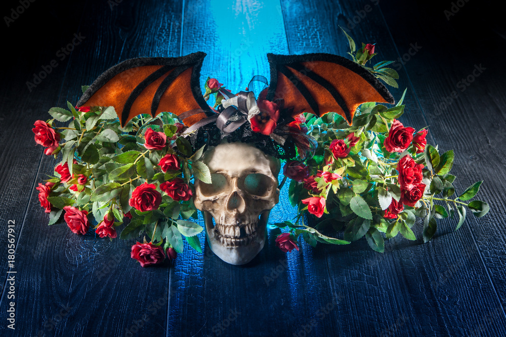 Skull with roses. Cult of Santa Muerte. A skull with vampire wings ...