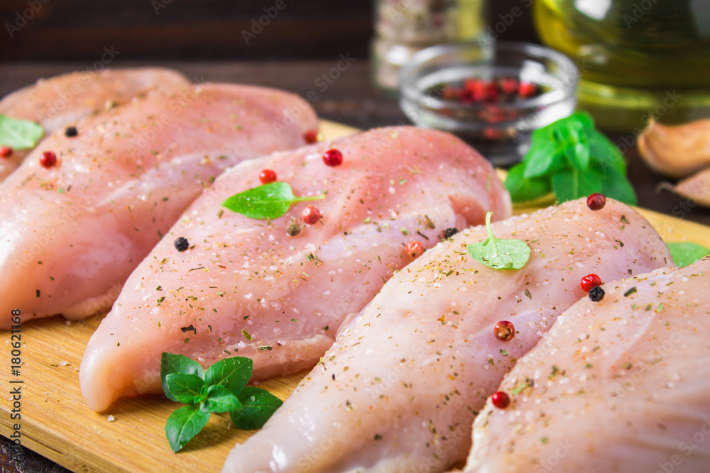 Raw chicken fillets on a cutting board against the background of a ...